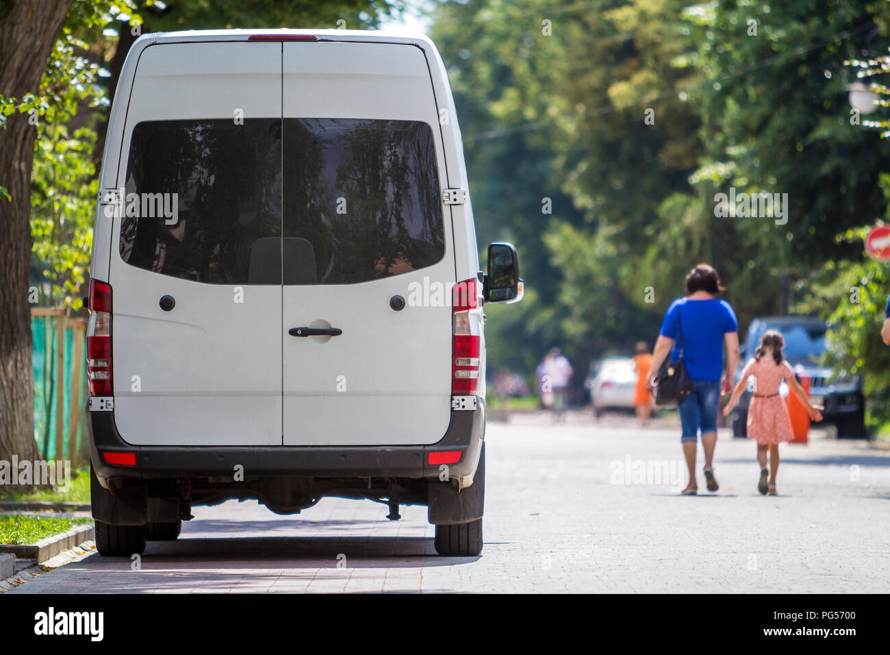 Back view of white passenger medium size commercial luxury minibus van ...