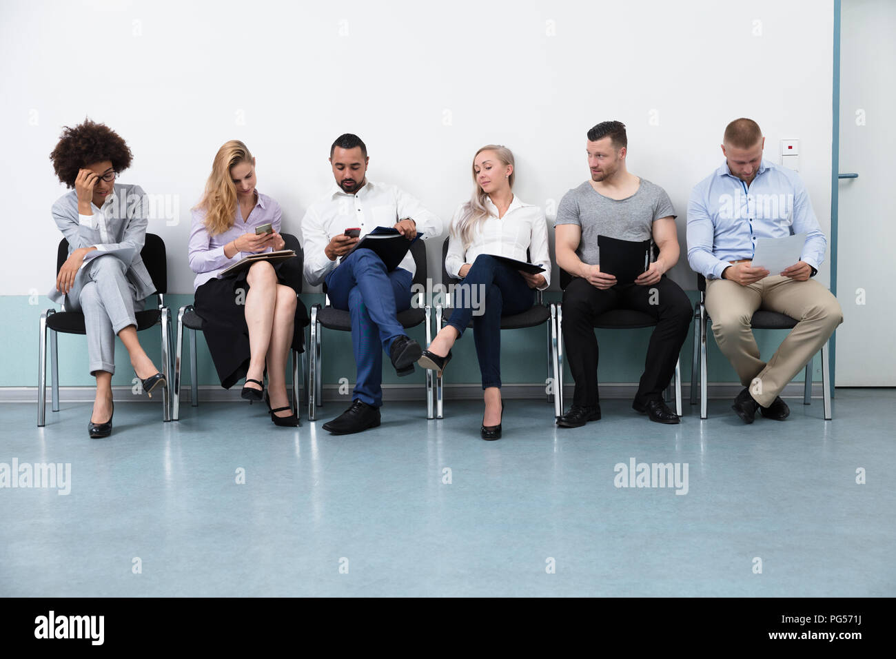 Candidates Sitting On Chair Waiting For An Interview Stock Photo - Alamy