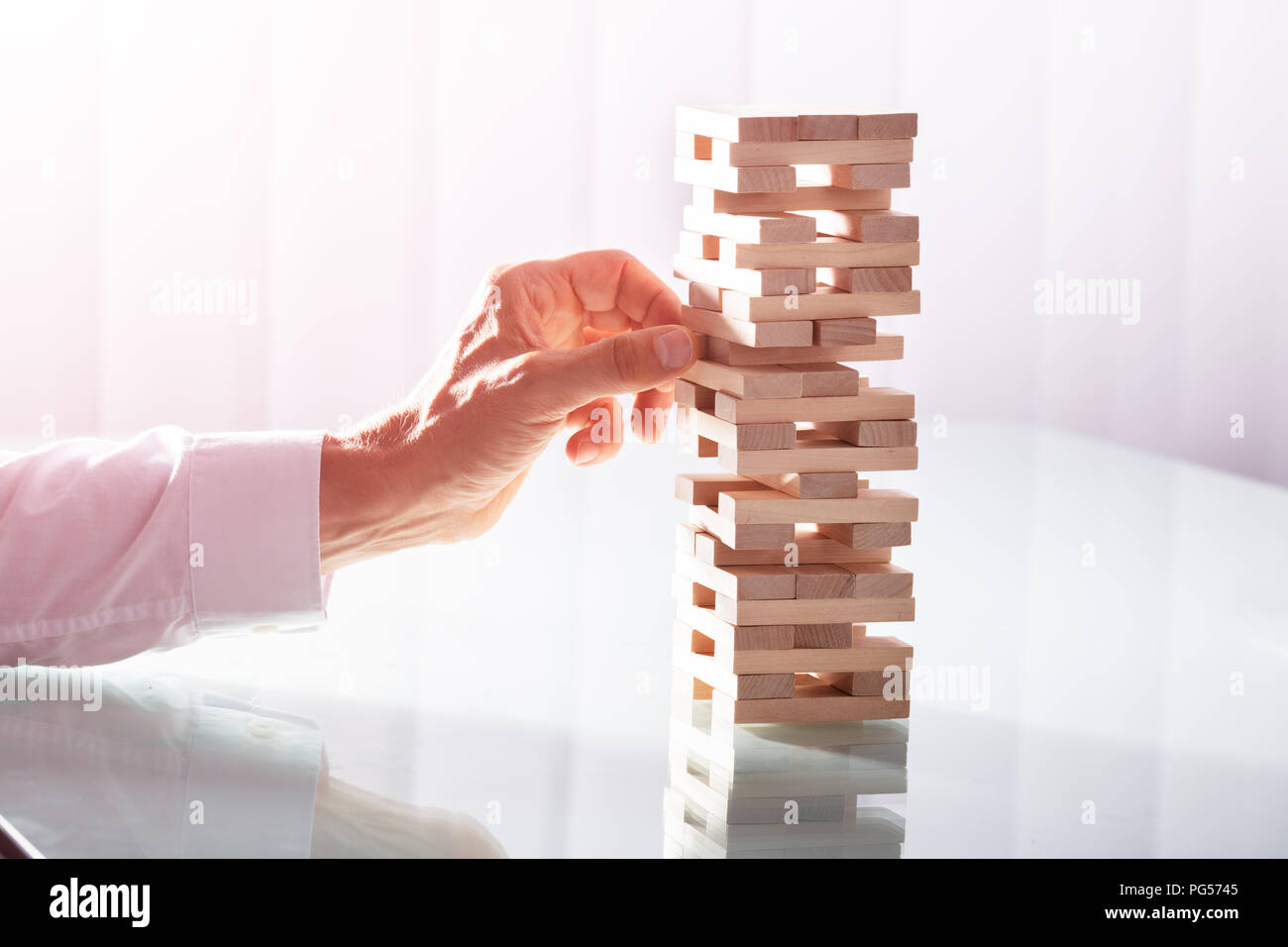 Close-up Of A Businessman's Hand Stacking Wooden Blocks Stock Photo - Alamy