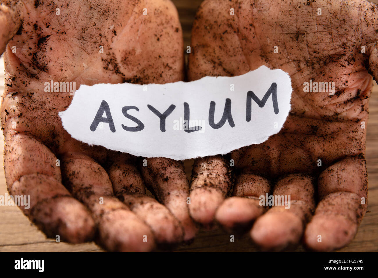 Man's Dirty Hands With Piece Of Paper Showing Asylum Word Stock Photo ...