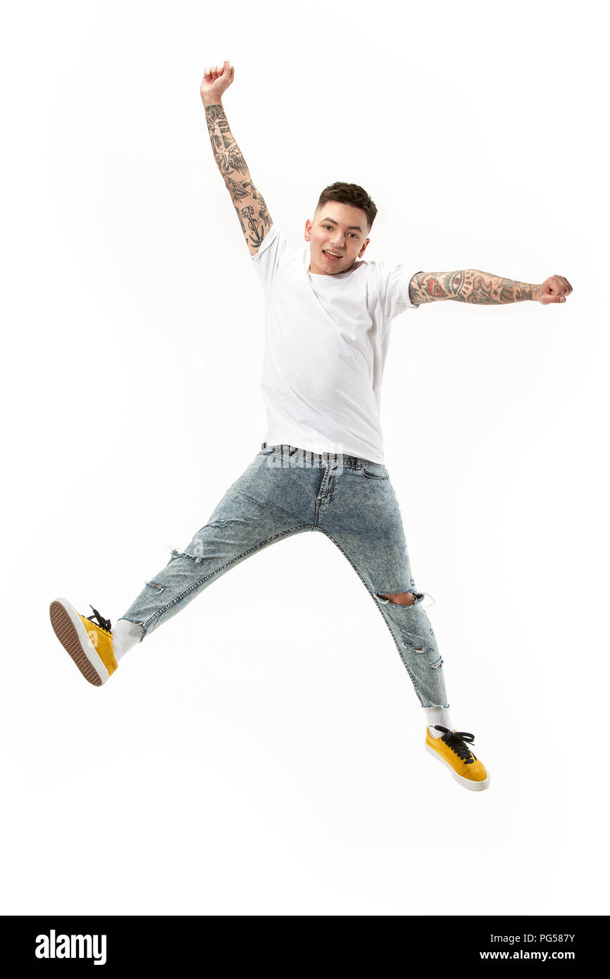 Freedom in moving. Mid-air shot of handsome happy young man jumping and ...