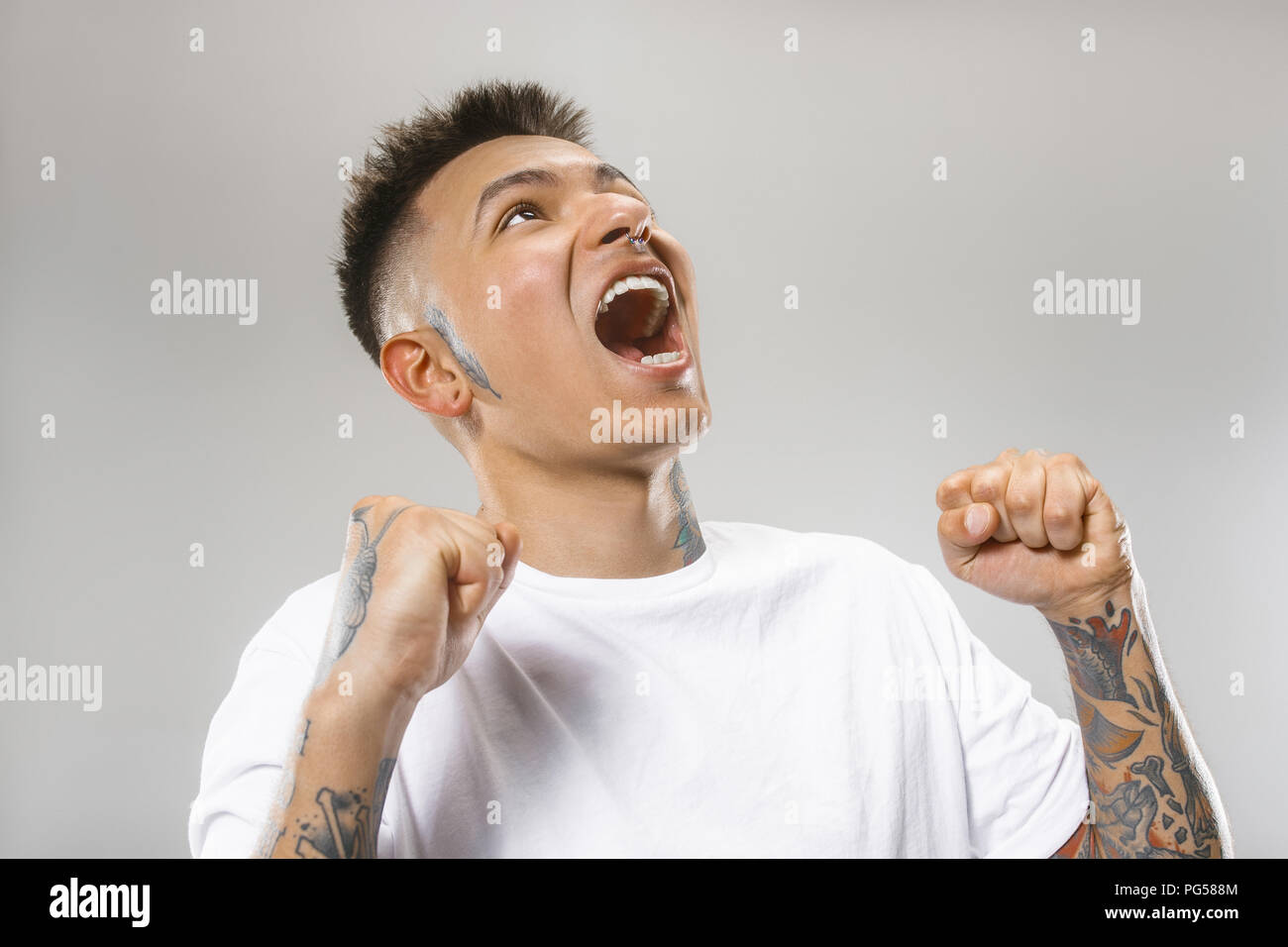 Screaming, hate, rage. Crying emotional angry man screaming on gray ...