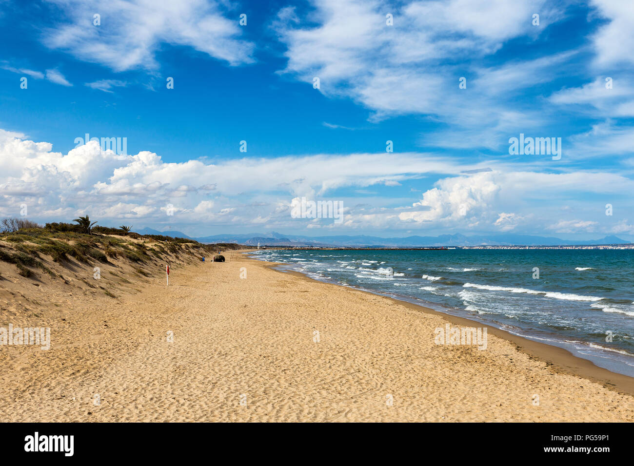 sandy seashore with dunes and clouds blue sky. Guardamar del Segura ...