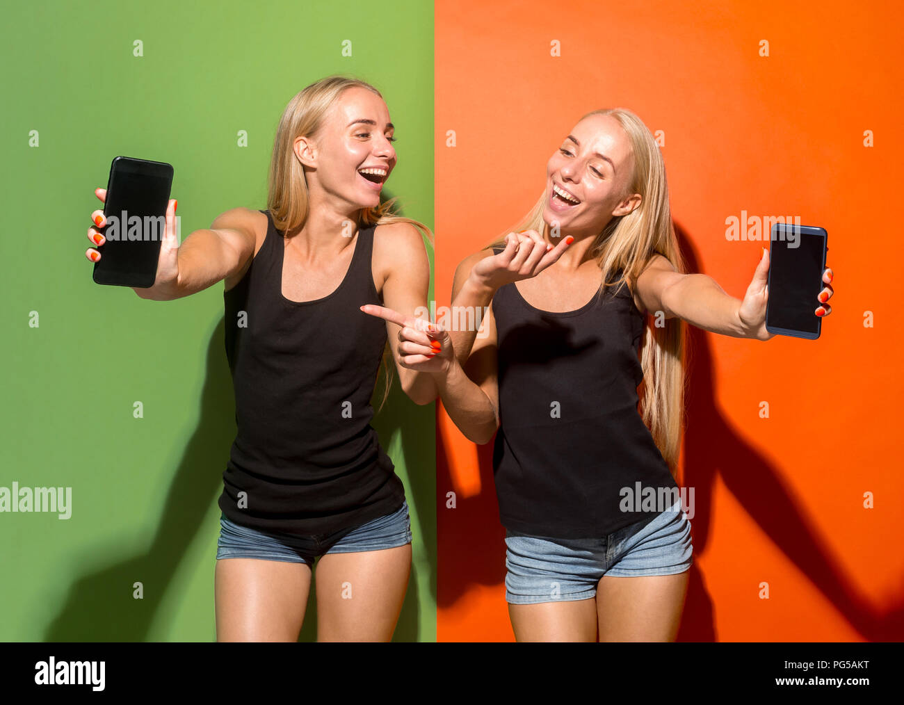 Portrait of a confident casual girls showing blank screen mobile phone ...