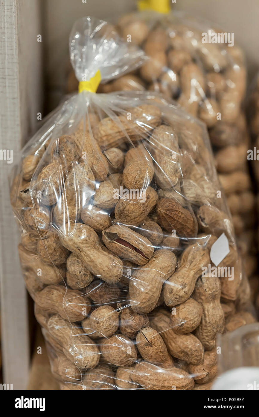 Raw shelled peanuts in plastic bags on display. Stock Image Stock Photo ...