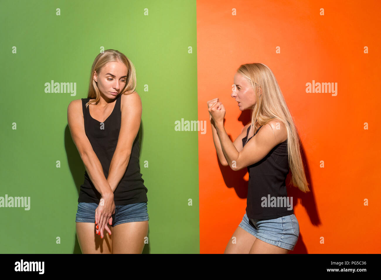 Angry woman. Aggressive woman standing isolated on trendy studio ...