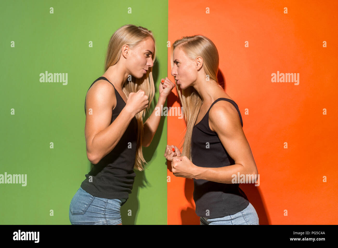 Angry women. Aggressive women standing isolated on trendy studio ...