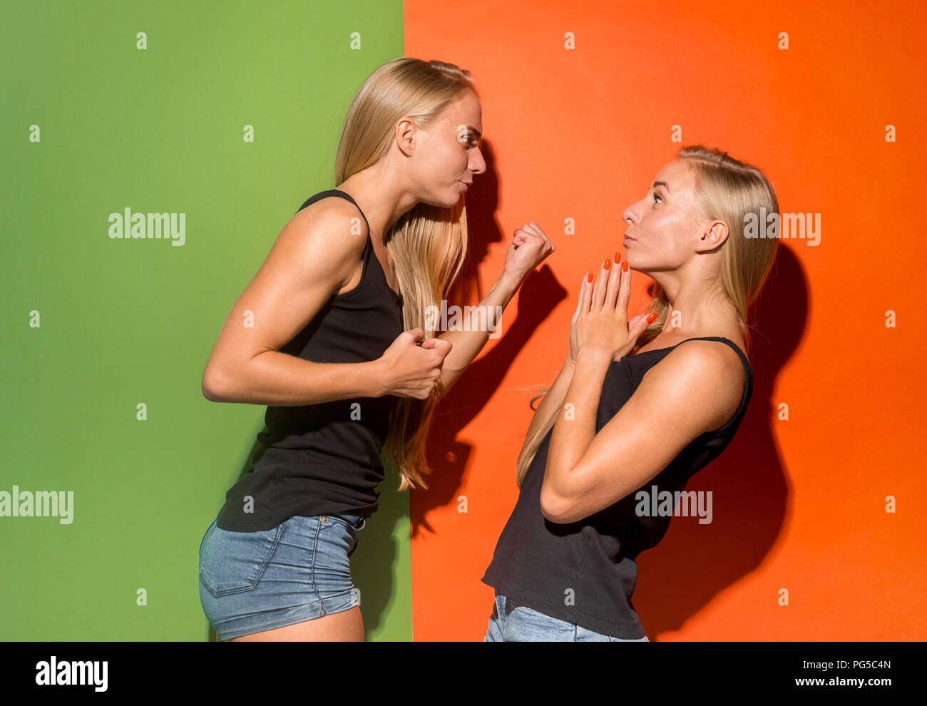 Angry women. Aggressive women standing isolated on trendy studio ...