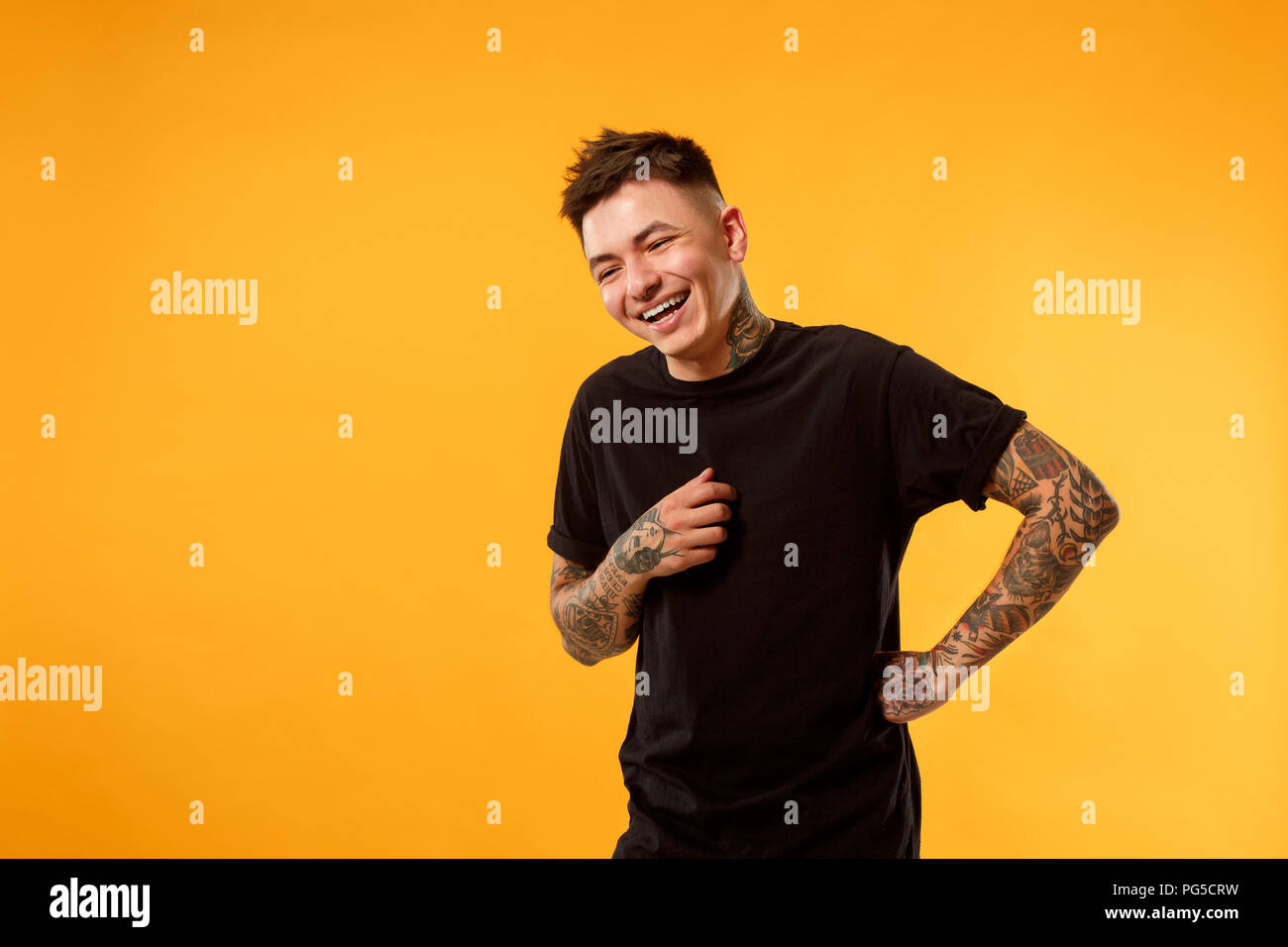 Happy business man standing and smiling isolated on studio background ...