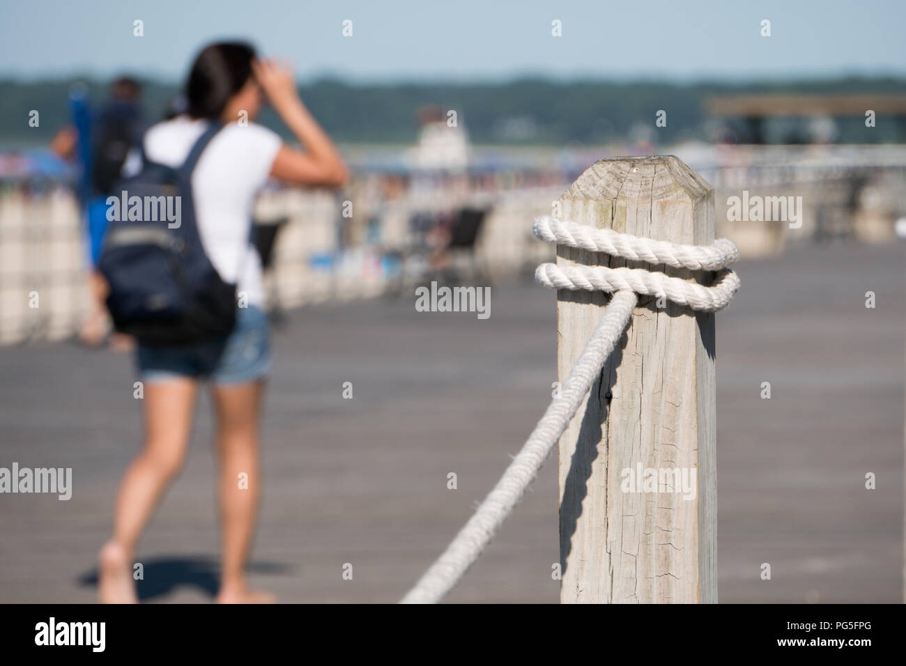 Shallow depth of field looking past railing post overlooking boardwalk ...