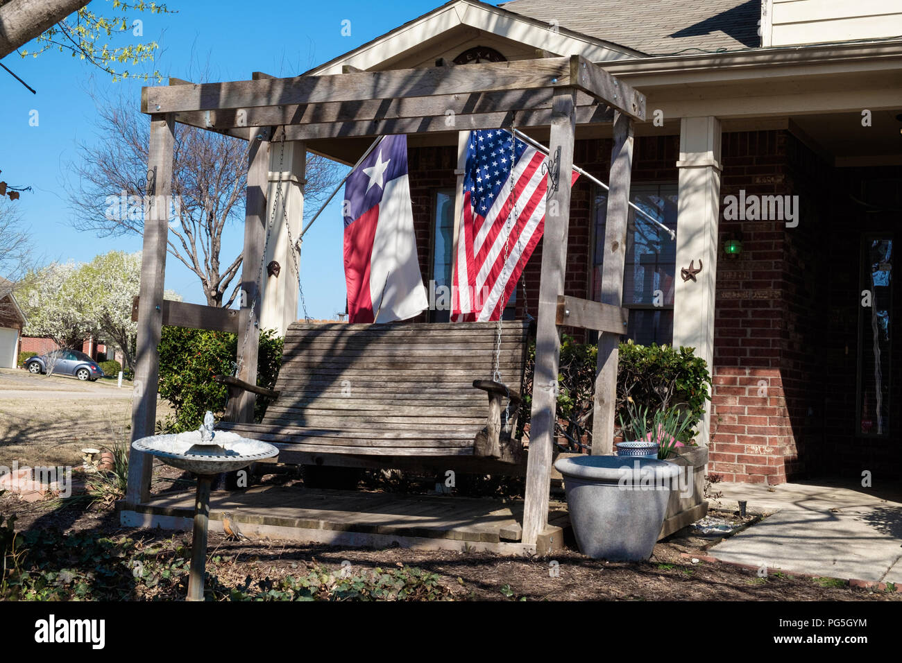 Texas Flag & American Flag on extended flag poles outside home in ...