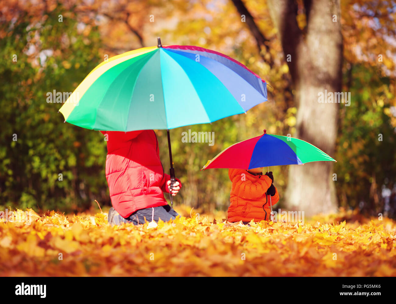 Children in yellow umbrella hi-res stock photography and images - Alamy