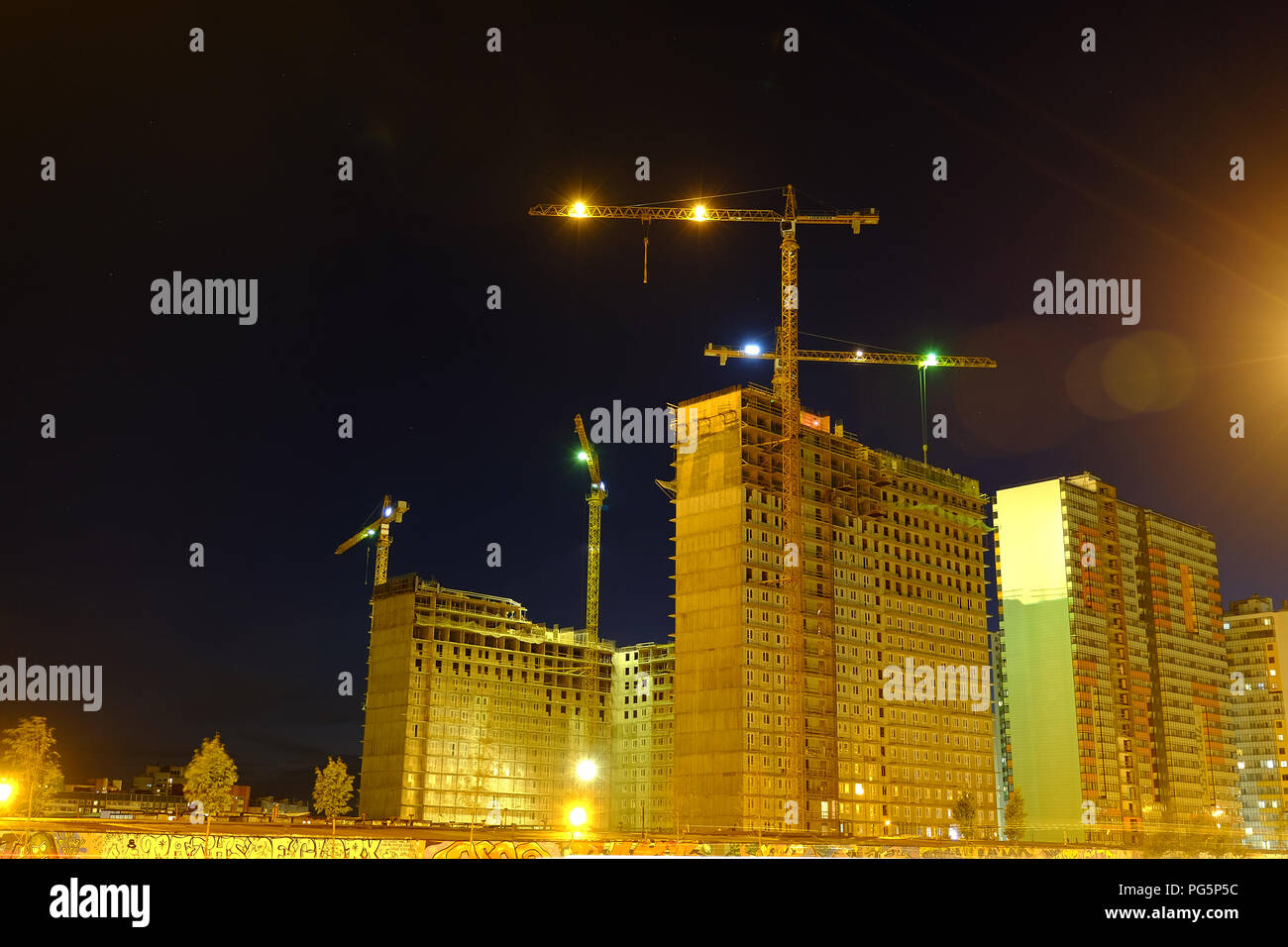 House construction. Night snapshot. Lighting of the motorway. Plumes of ...