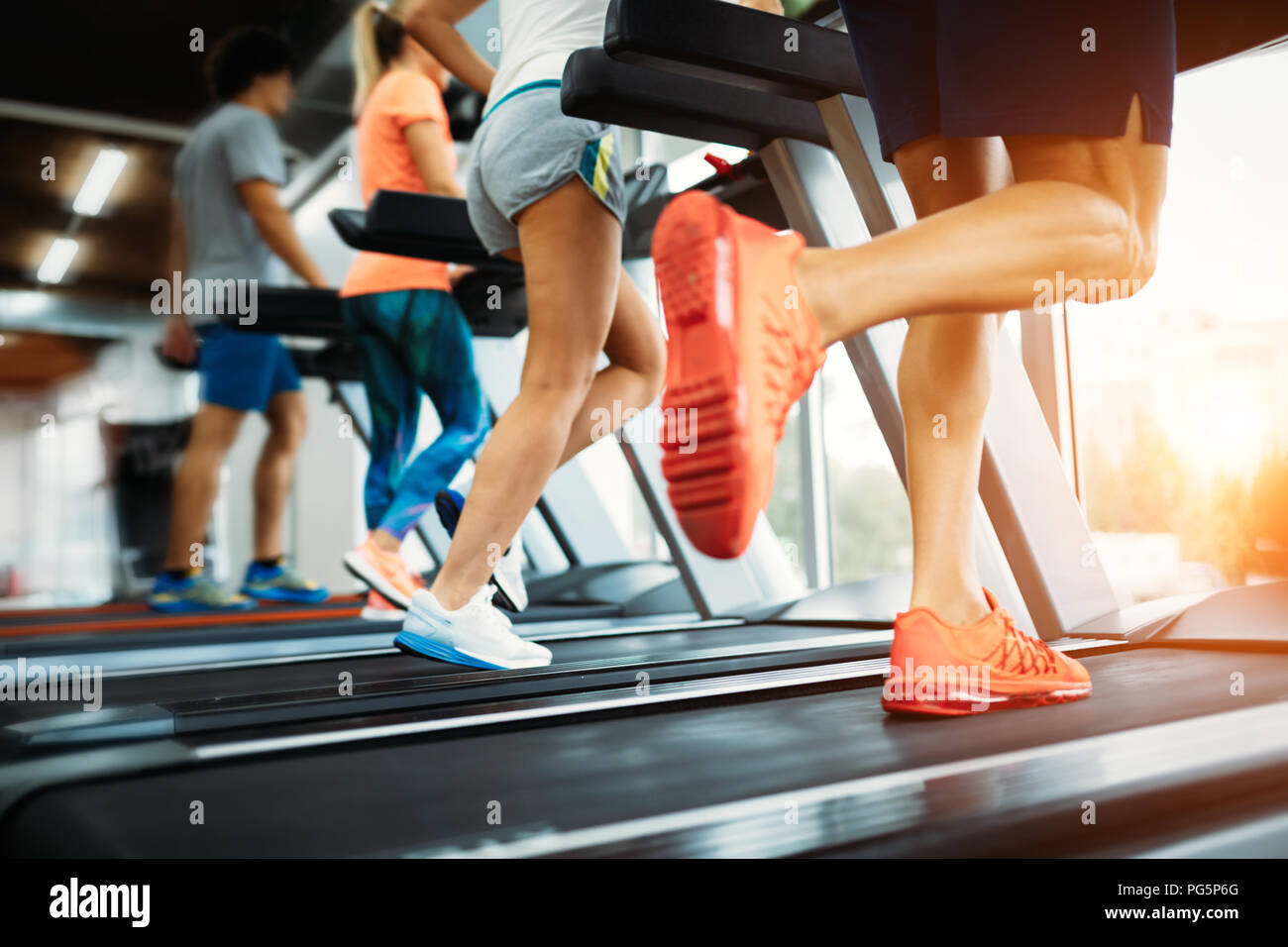Picture of people running on treadmill in gym Stock Photo - Alamy