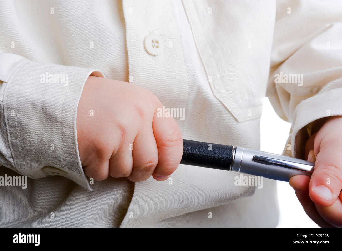 Baby holding a pen in his hand on a white background Stock Photo - Alamy