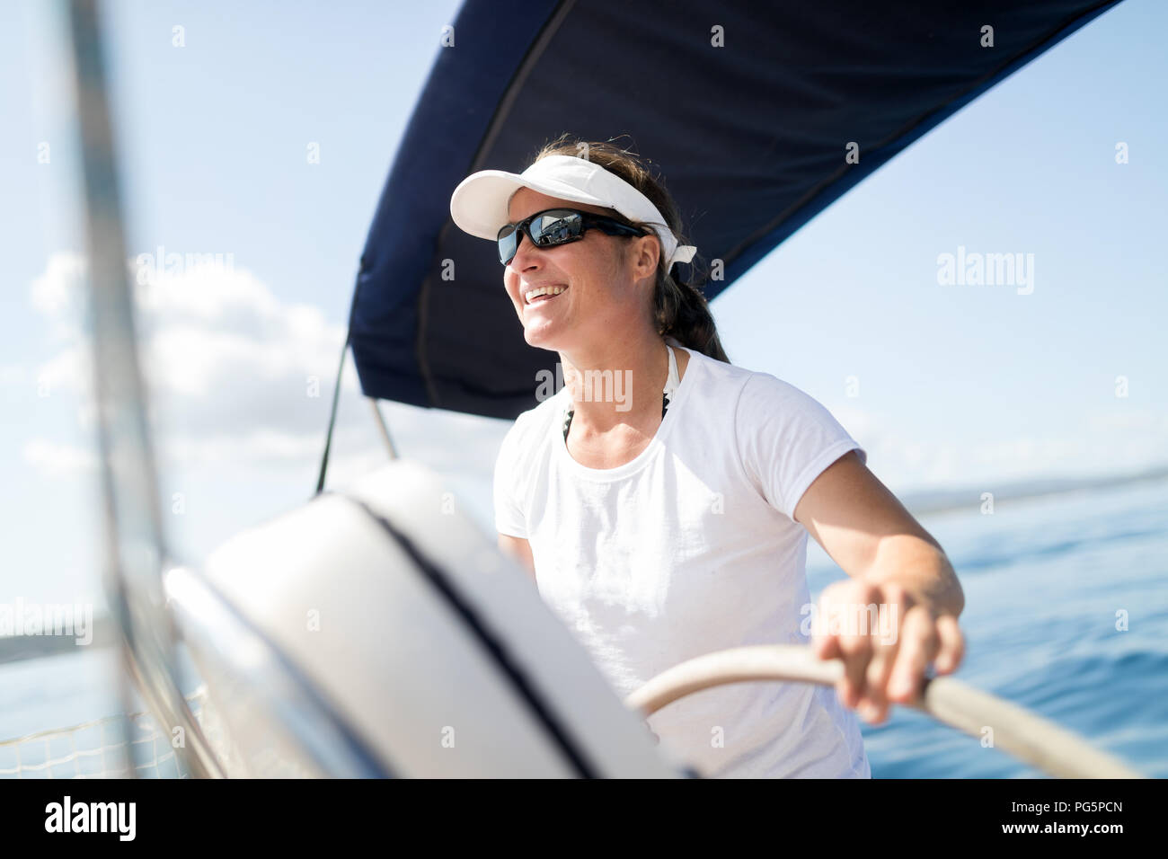 Attractive strong woman sailing with her boat Stock Photo - Alamy