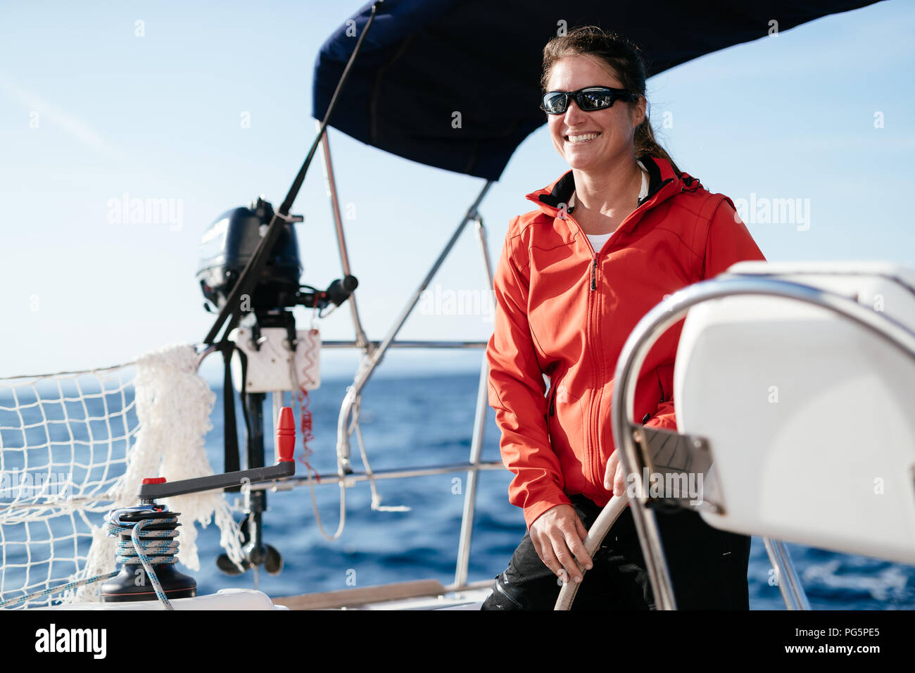 Attractive strong woman sailing with her boat Stock Photo - Alamy