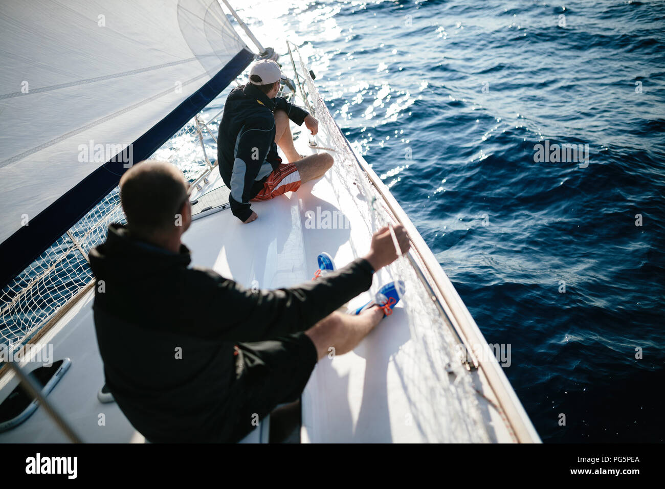 Handsome strong men sailing with their boat Stock Photo - Alamy