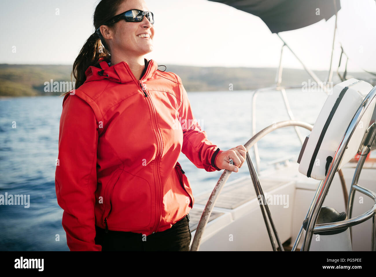 Attractive strong woman sailing with her boat Stock Photo - Alamy