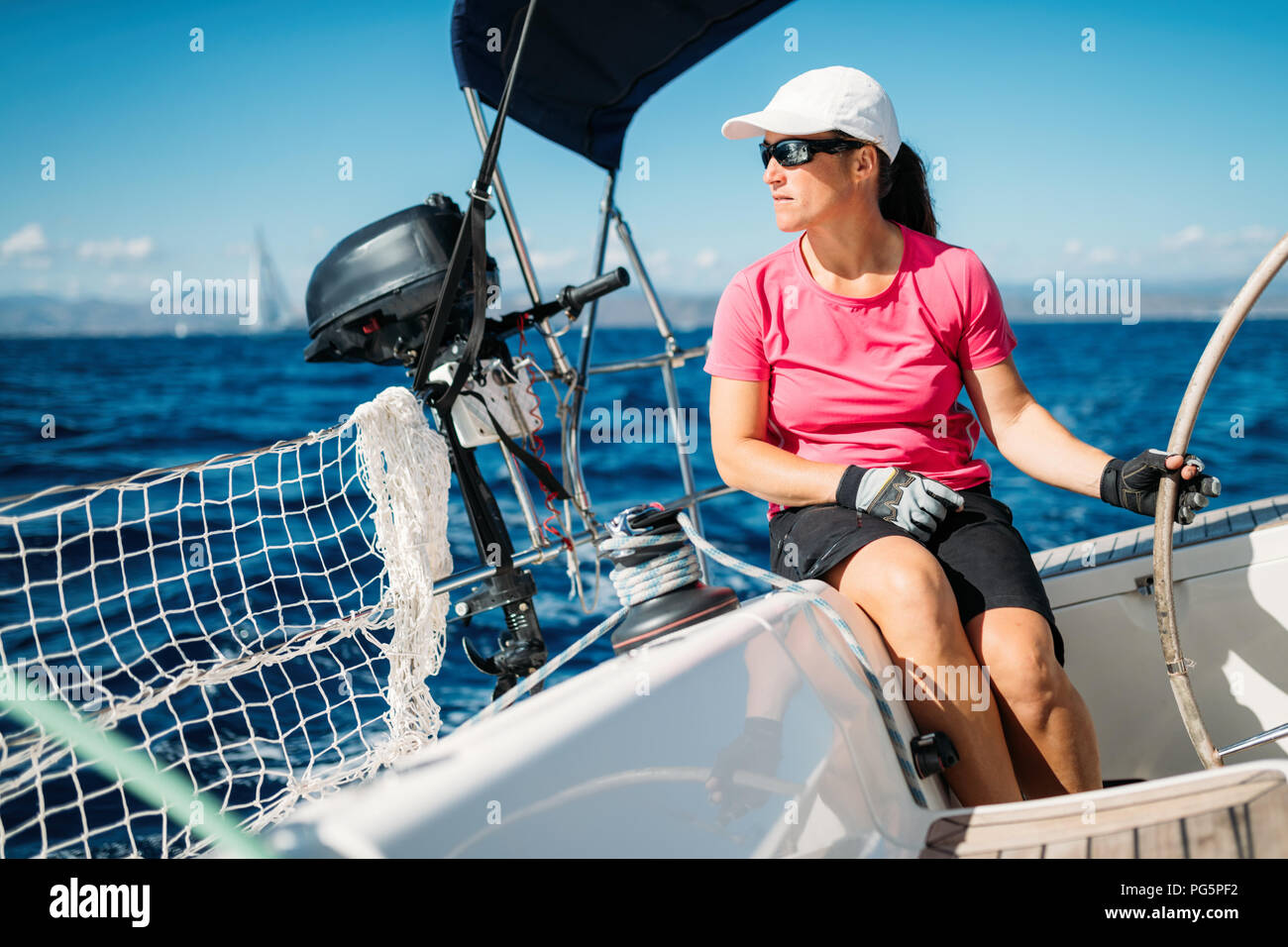 Happy strong woman sailing with her boat Stock Photo - Alamy