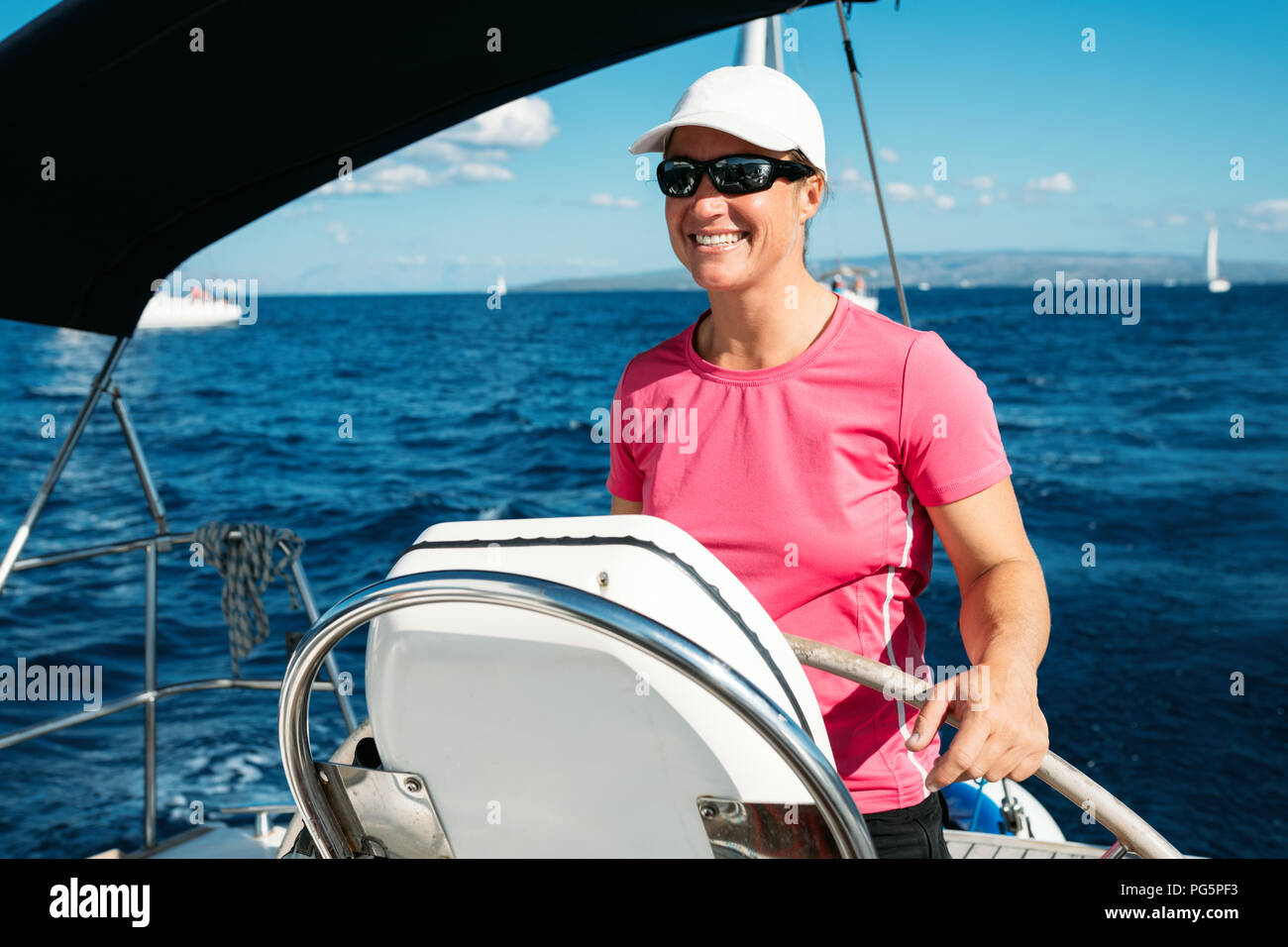 Happy strong woman sailing with her boat Stock Photo - Alamy