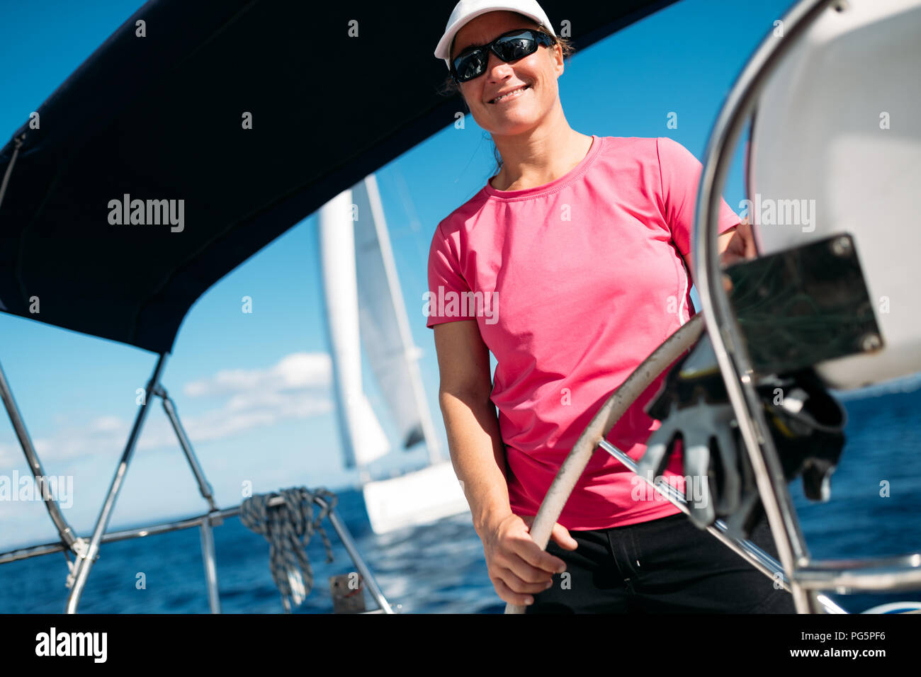 Happy strong woman sailing with her boat Stock Photo - Alamy