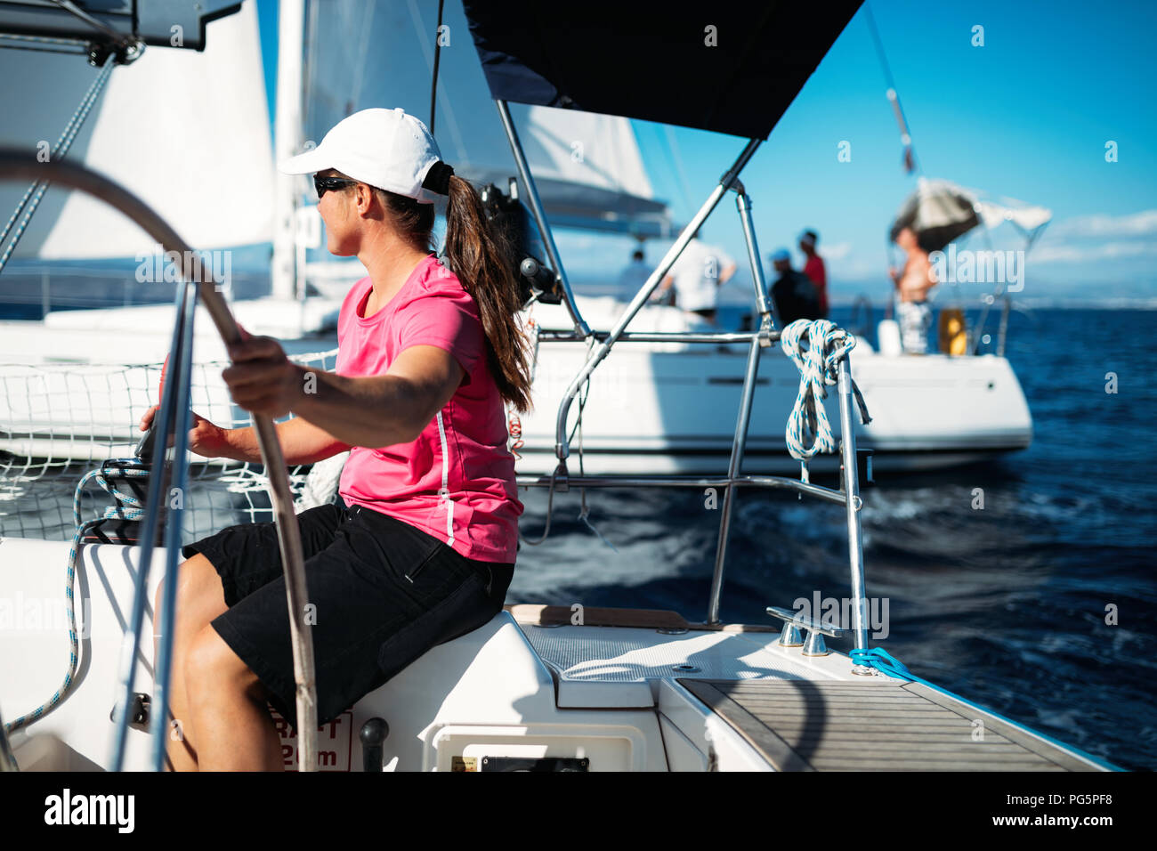 Happy strong woman sailing with her boat Stock Photo - Alamy