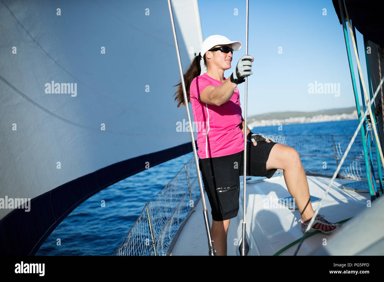 Happy strong woman sailing with her boat Stock Photo - Alamy