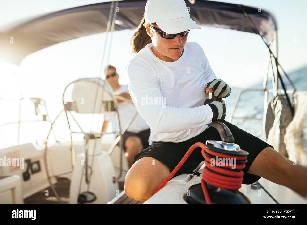 Attractive strong woman sailing with her boat Stock Photo - Alamy