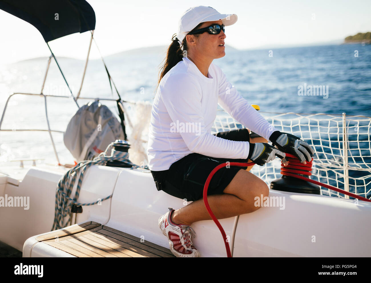 Attractive strong woman sailing with her boat Stock Photo - Alamy
