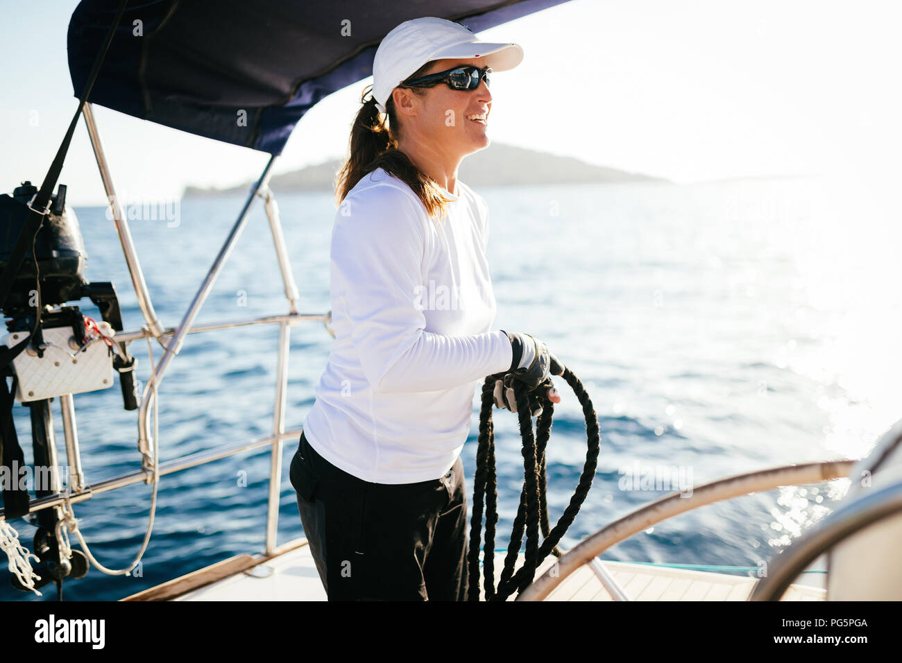 Attractive strong woman sailing with her boat Stock Photo - Alamy