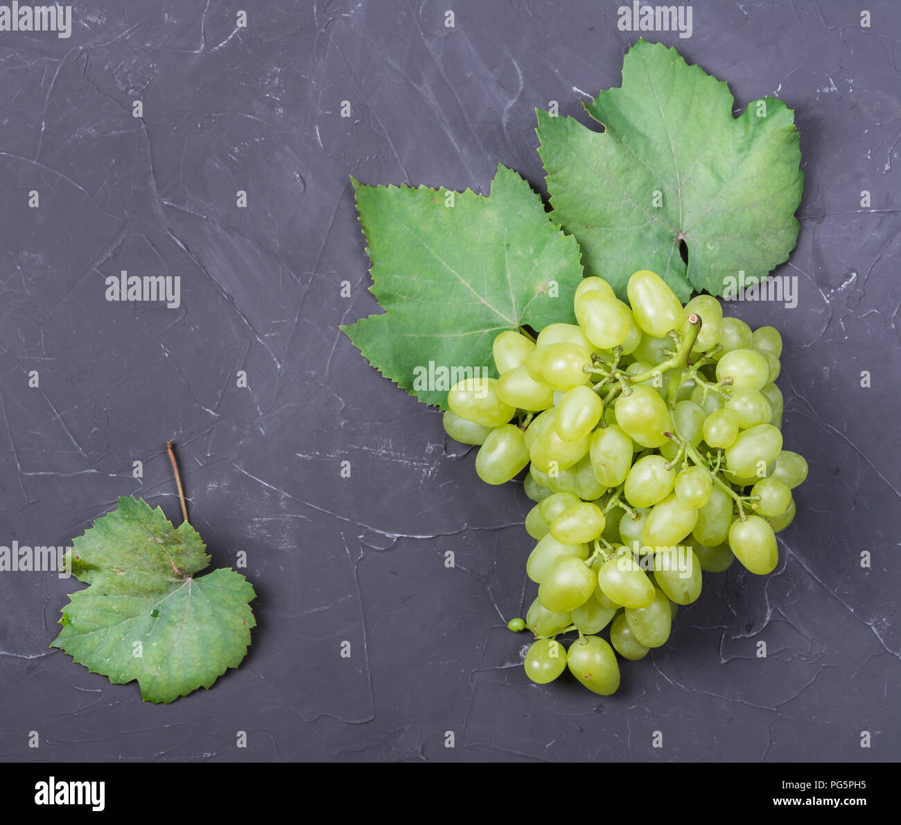 Fresh tasty grape with branch on dark background Stock Photo - Alamy