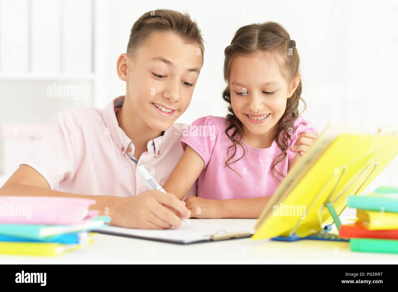 Brother and sister doing homework at home Stock Photo - Alamy