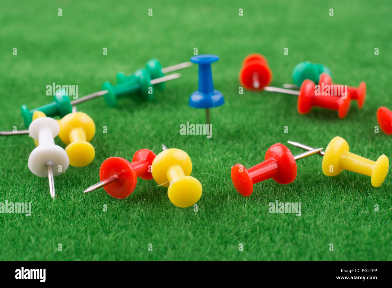 Colorful pins on green grass Stock Photo - Alamy