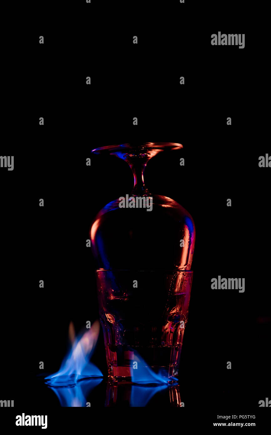 close up view of glasses and burning sanbuca alcohol drink around on ... close up view of glasses and burning sanbuca alcohol drink around on ...