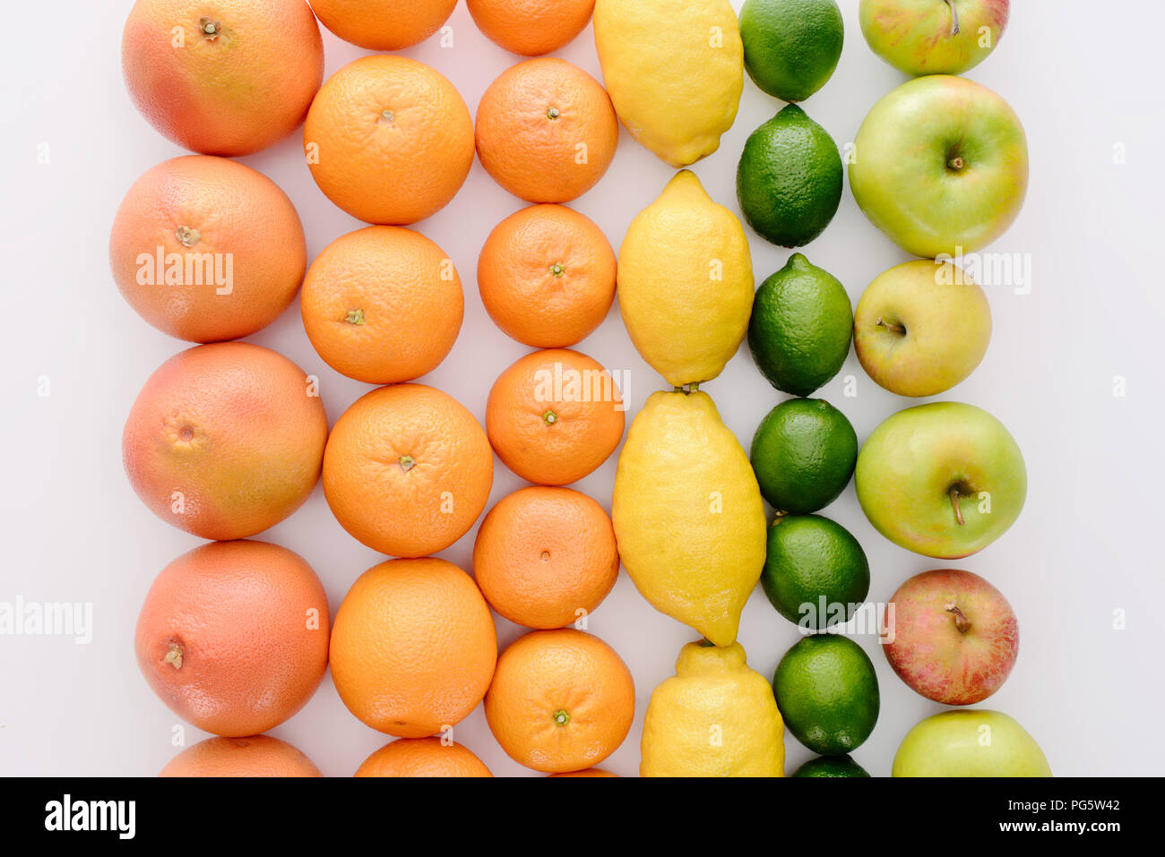 top view of composition of various ripe fruits in rows on white ...