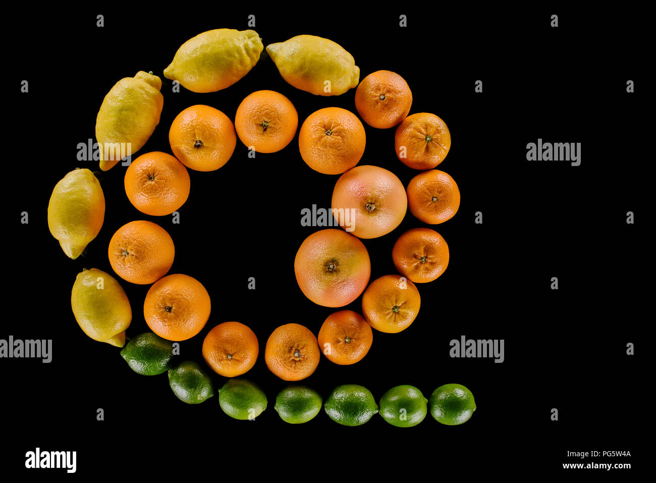 top view of various fresh citrus fruits composition in spiral shape ...