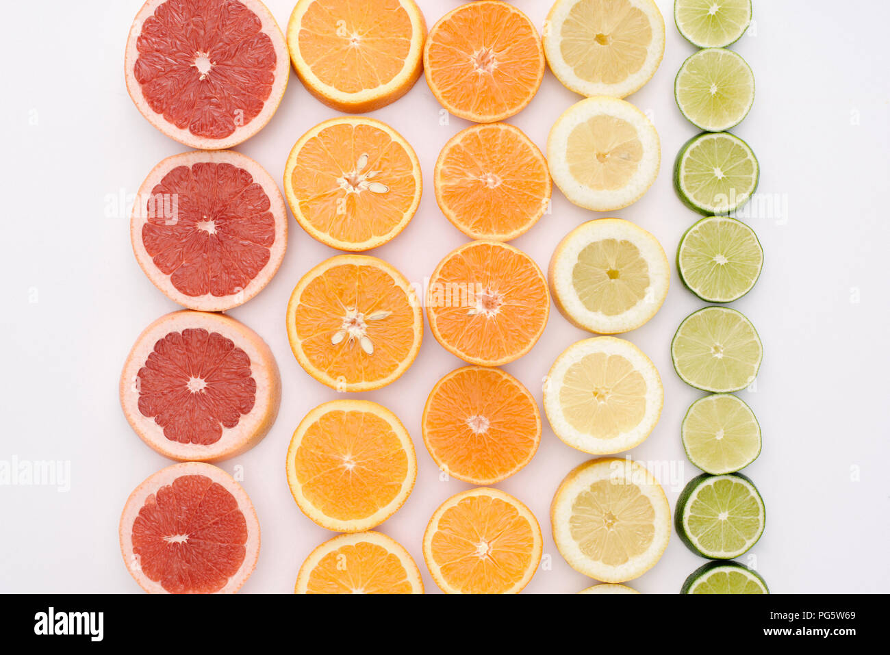 top view of various citrus fruits slices in rows on white surface Stock ...