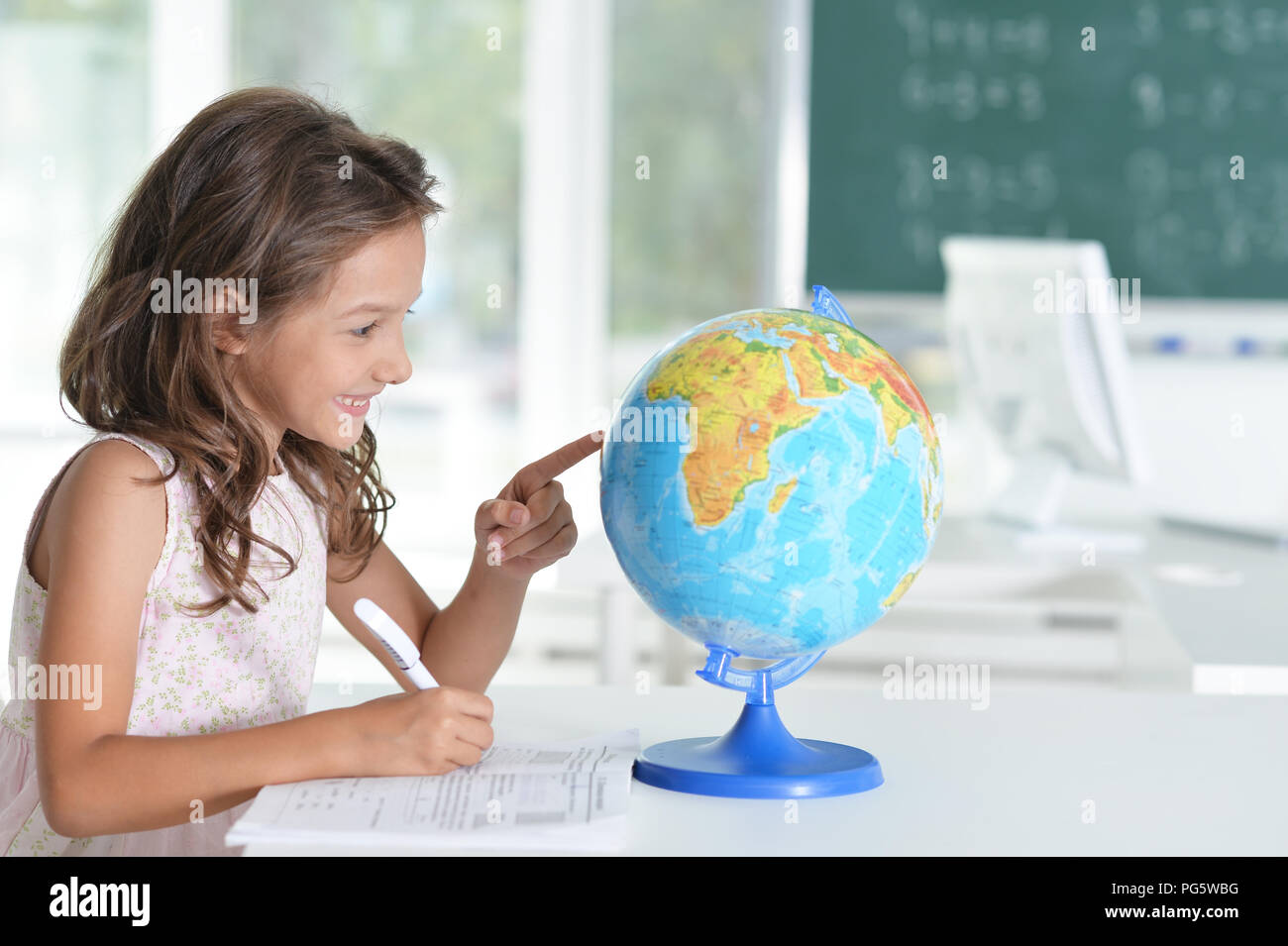 Portrait of cute little girl doing homework Stock Photo - Alamy