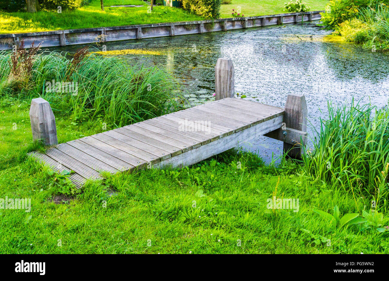 wooden pier bridge at the park pond Stock Photo - Alamy