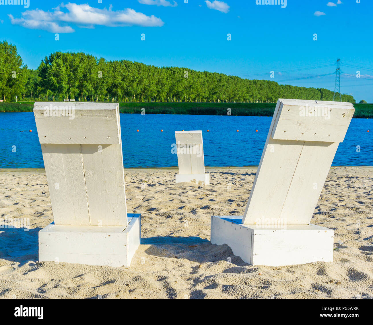 couple of white beach seats at the beach lake Stock Photo - Alamy