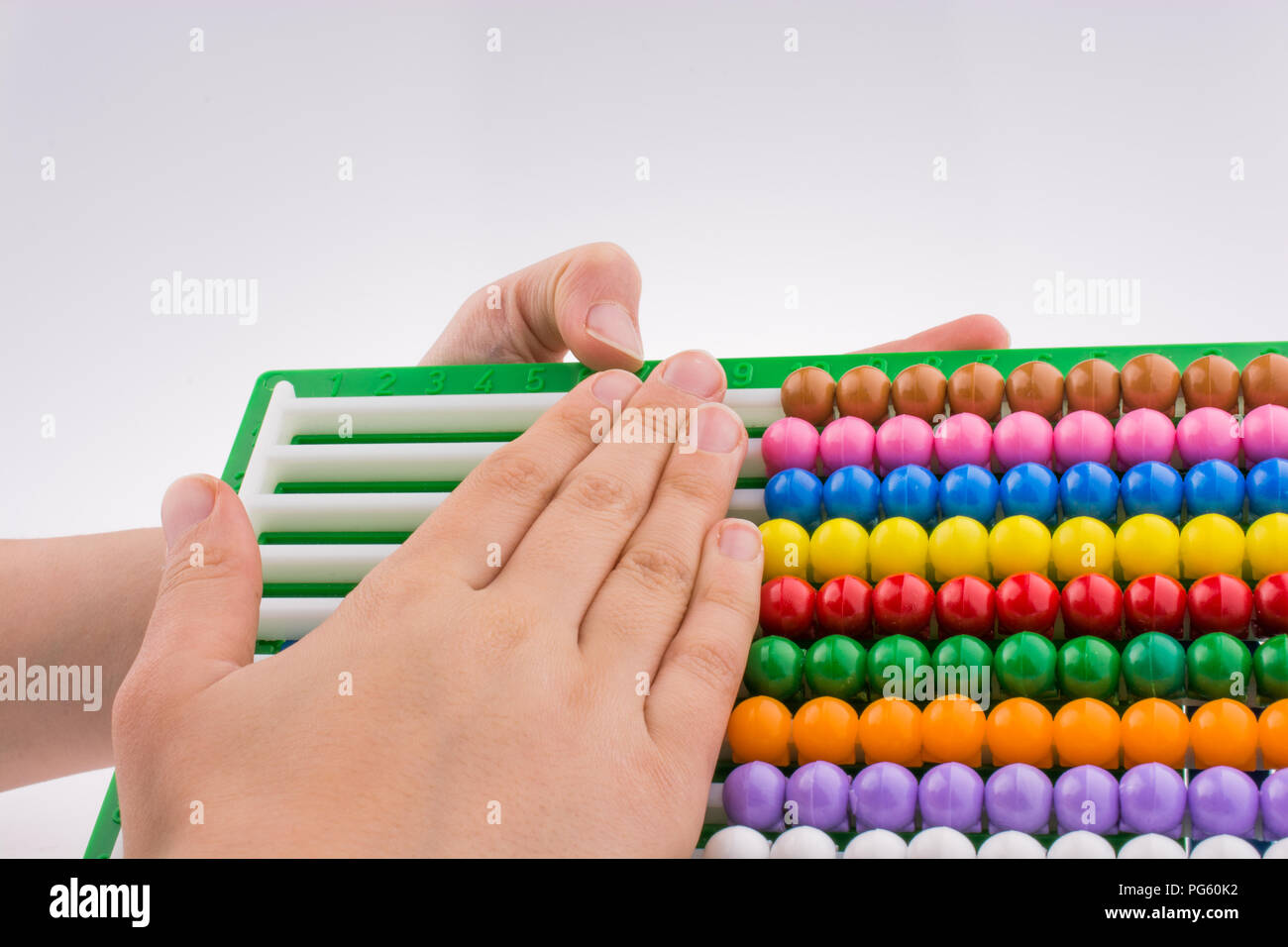 Hand using a color abacus Stock Photo - Alamy