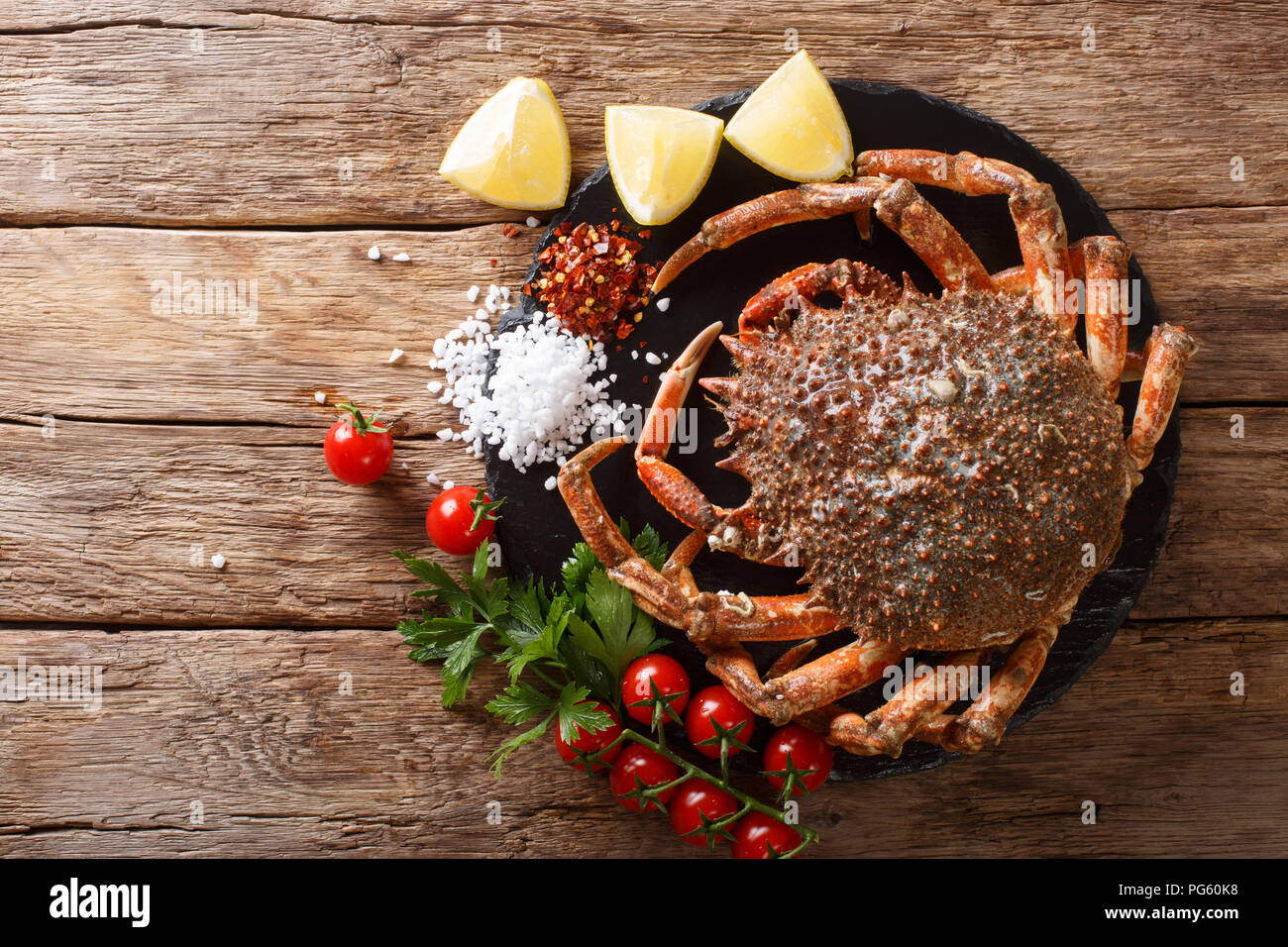 Seafood background: raw edible spider crab with ingredients close-up on ...