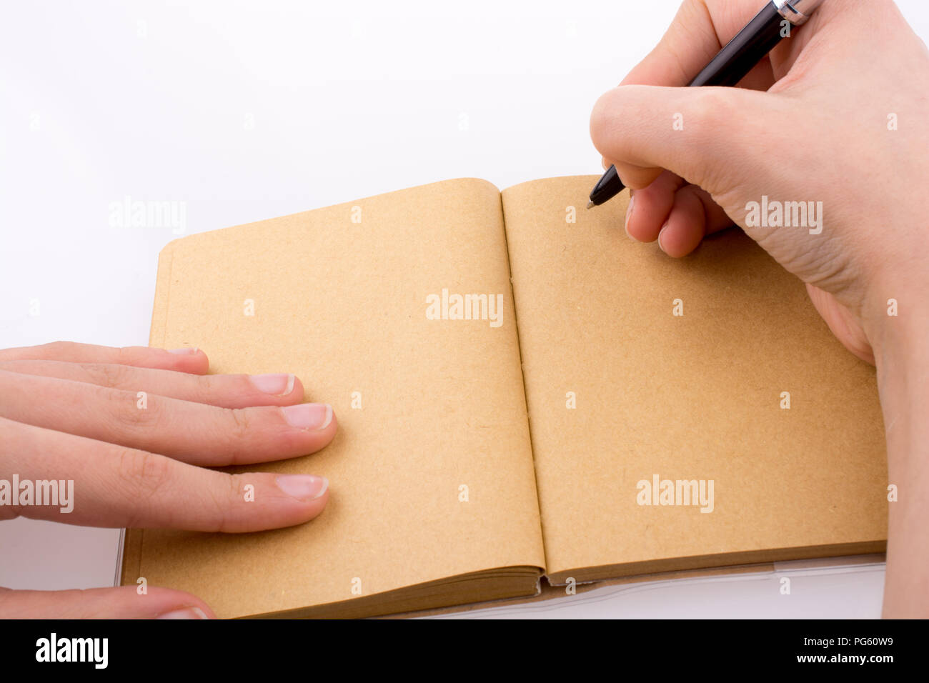 Hand writing on an empty notebook with a pen Stock Photo - Alamy