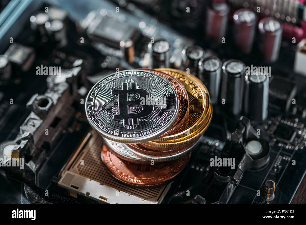 close up view of pile of bitcoins on computer motherboard Stock Photo ...