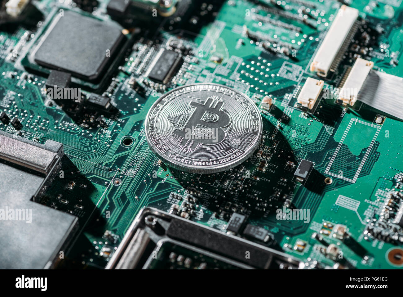 close up view of silver bitcoin on computer motherboard Stock Photo - Alamy
