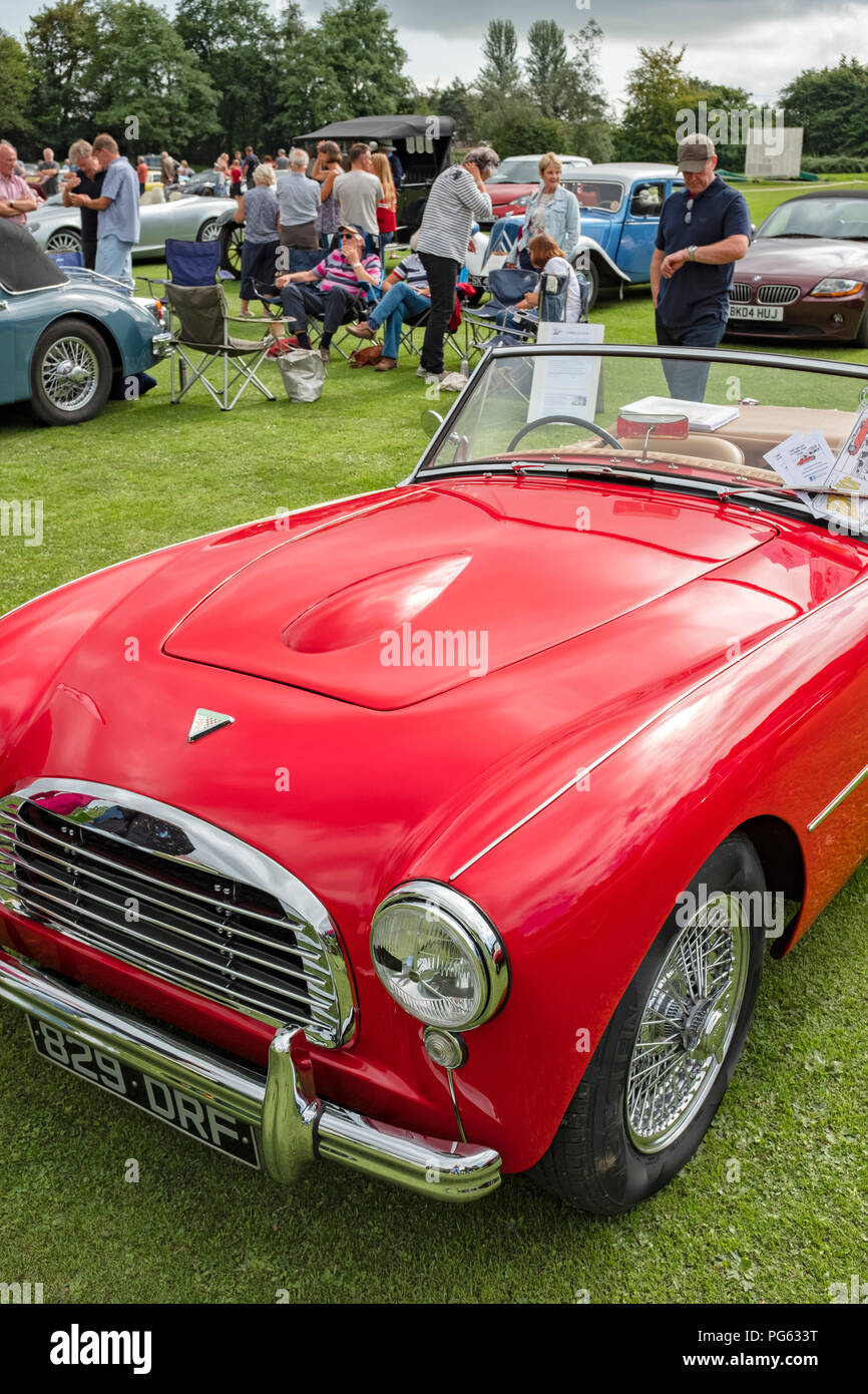 A red 1950s Swallow Doretti roadster at a classic car show in Wales ...