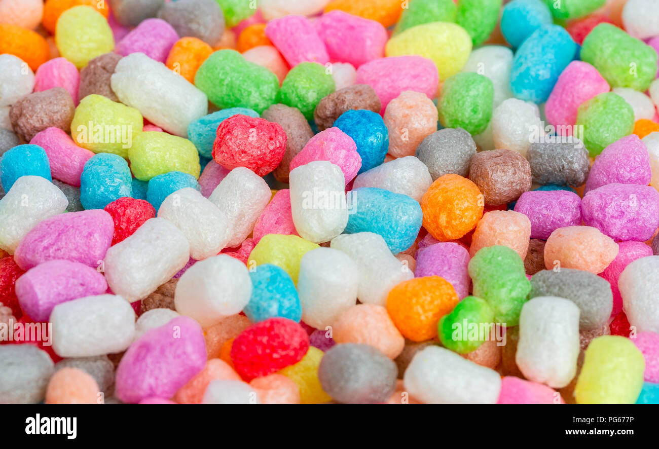 Multicolored corn balls lie on the table. Background. A game for ...