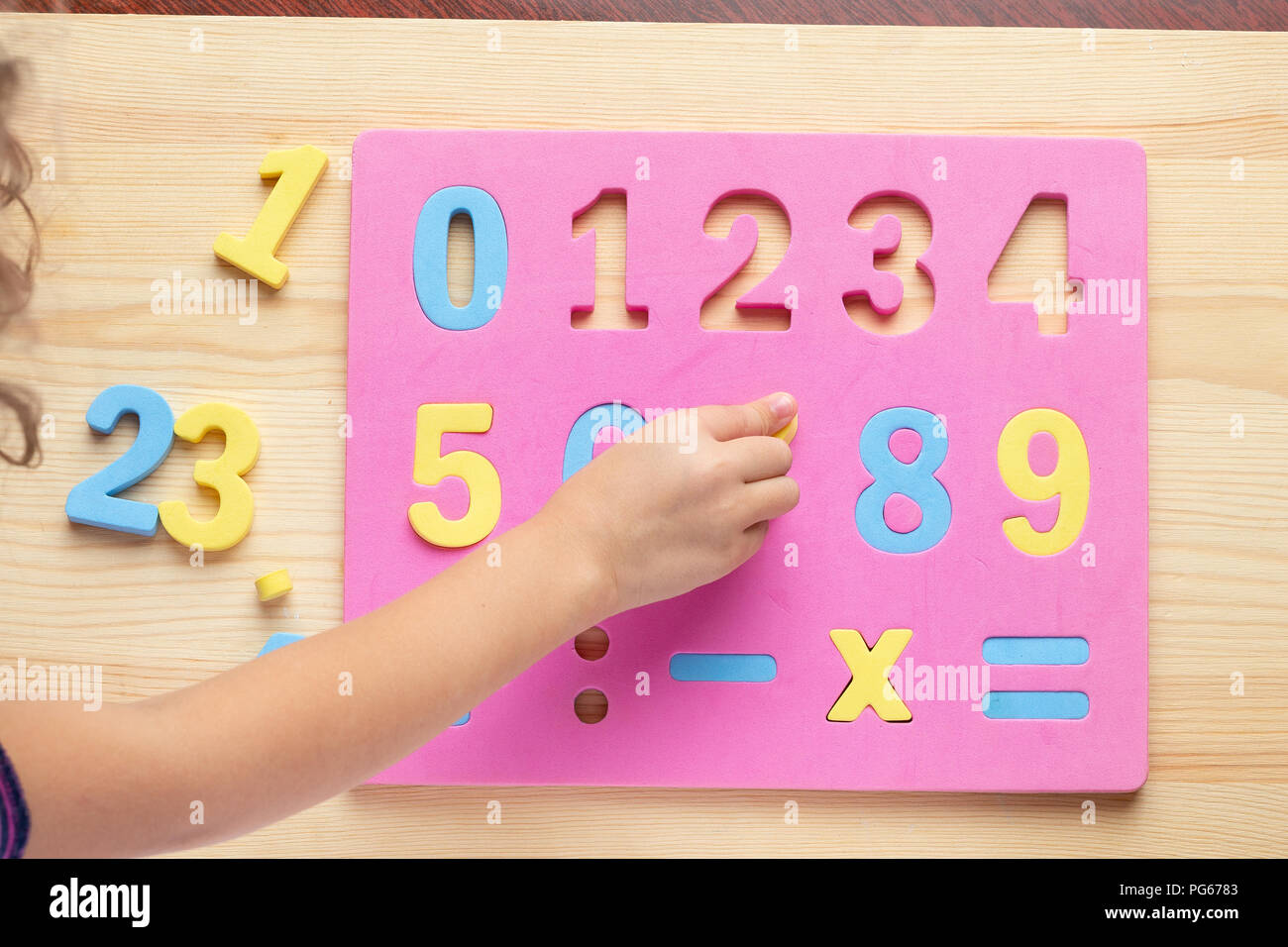 The child is studying the numbers and the account. Arranges the colored ...