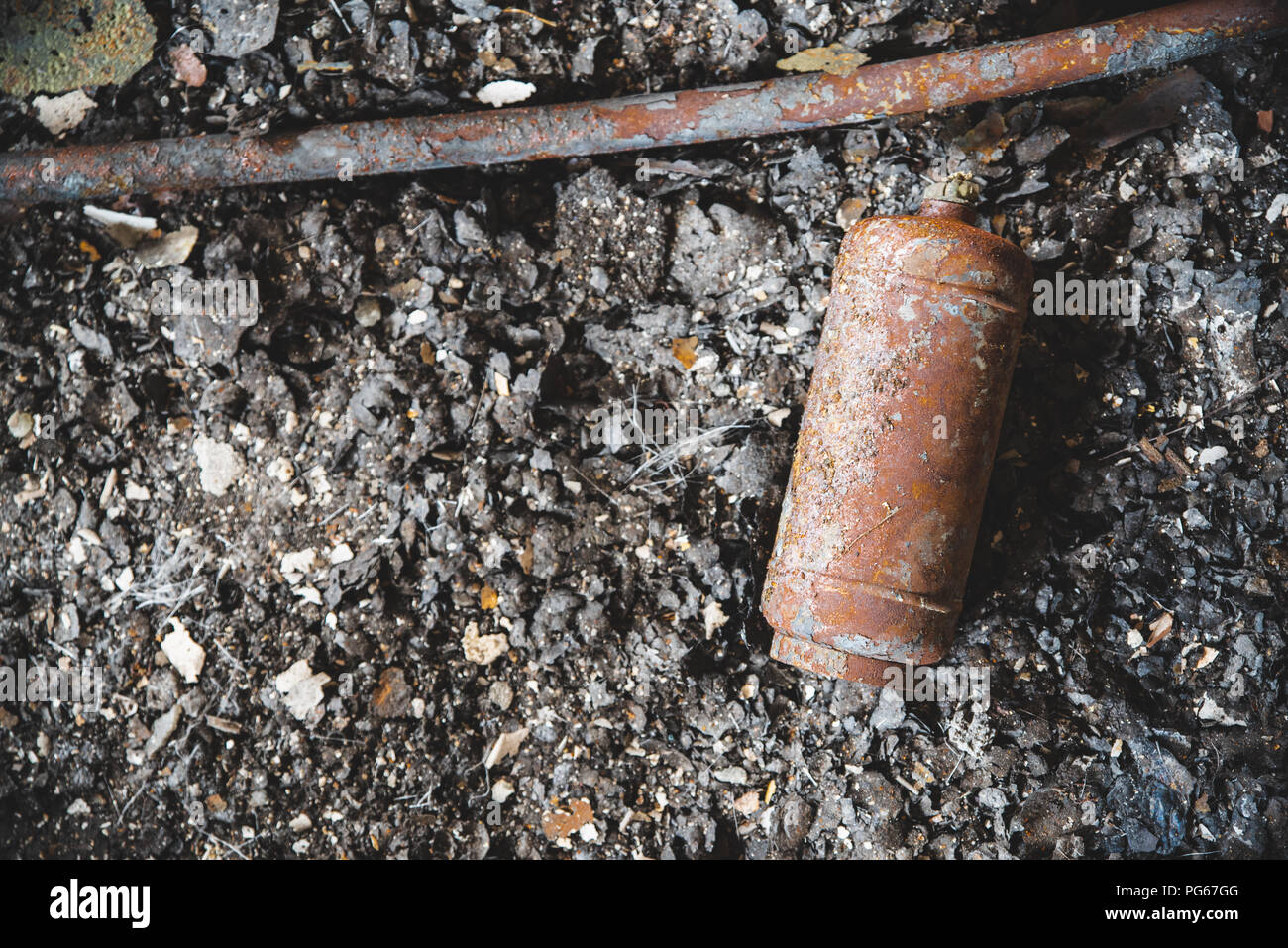 Fire extinguisher on burned floor, ash everywhere. After a fire. Top ...